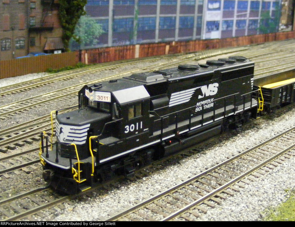 NS 3011 waits with a local in tow.